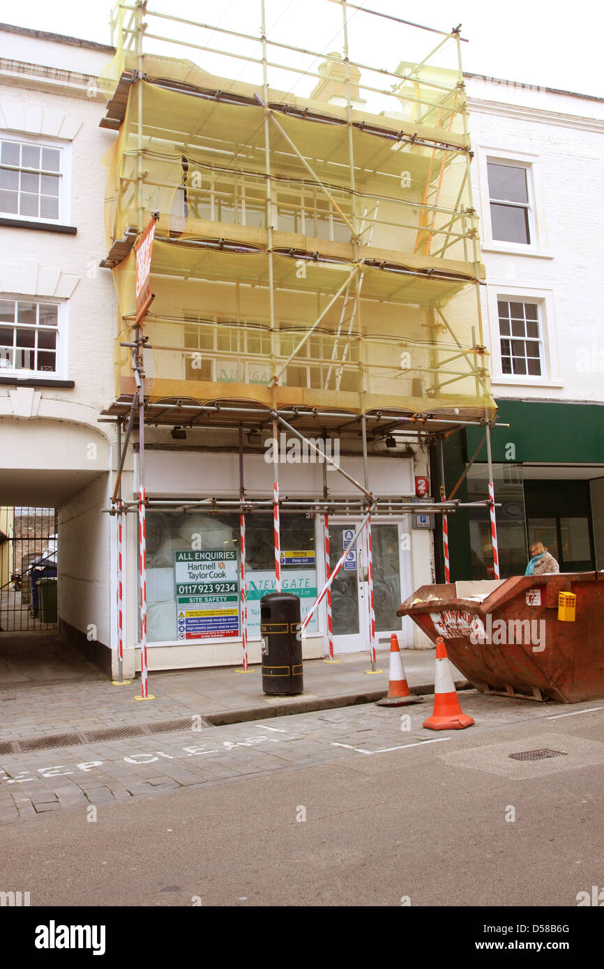 Contractors access scaffolding erected outside a shop that is being ...