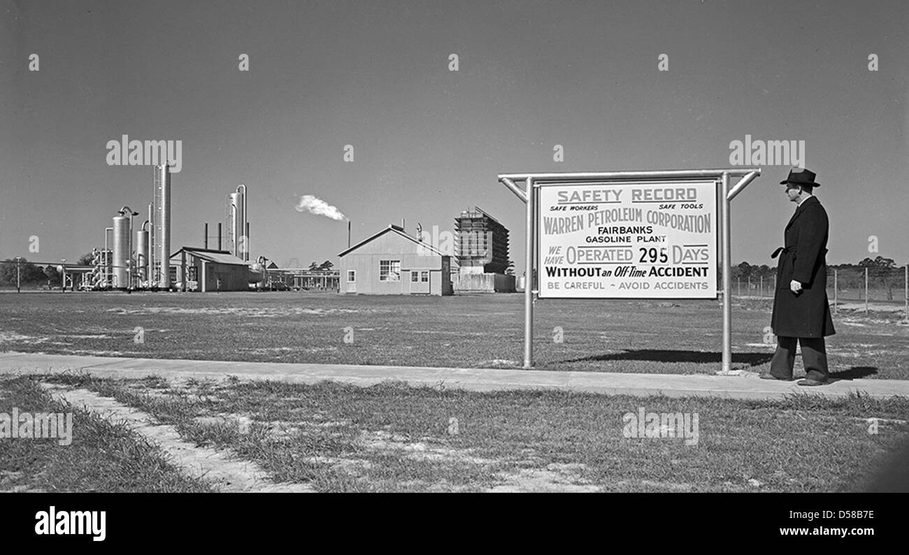 The photograph depicts employees and facilities of Warren Petroleum Co ...