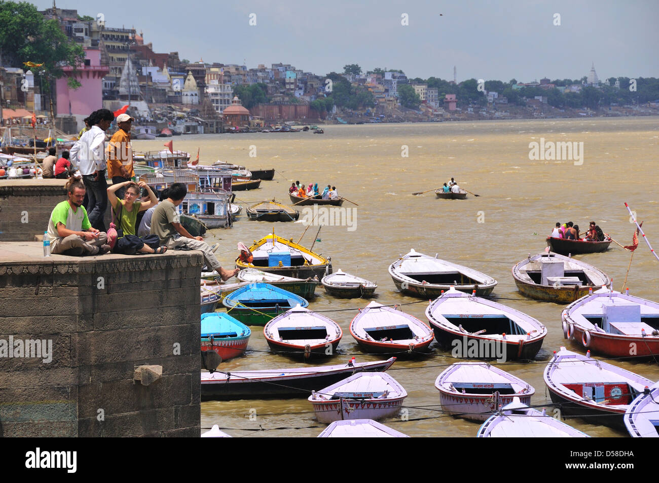 People relaxing at the ghat by the Ganges River in Varanasi Stock Photo ...