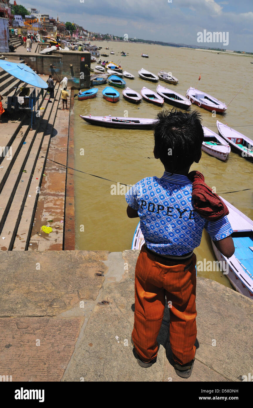 Boy at the ghat by the Ganges river in Varanasi Stock Photo - Alamy