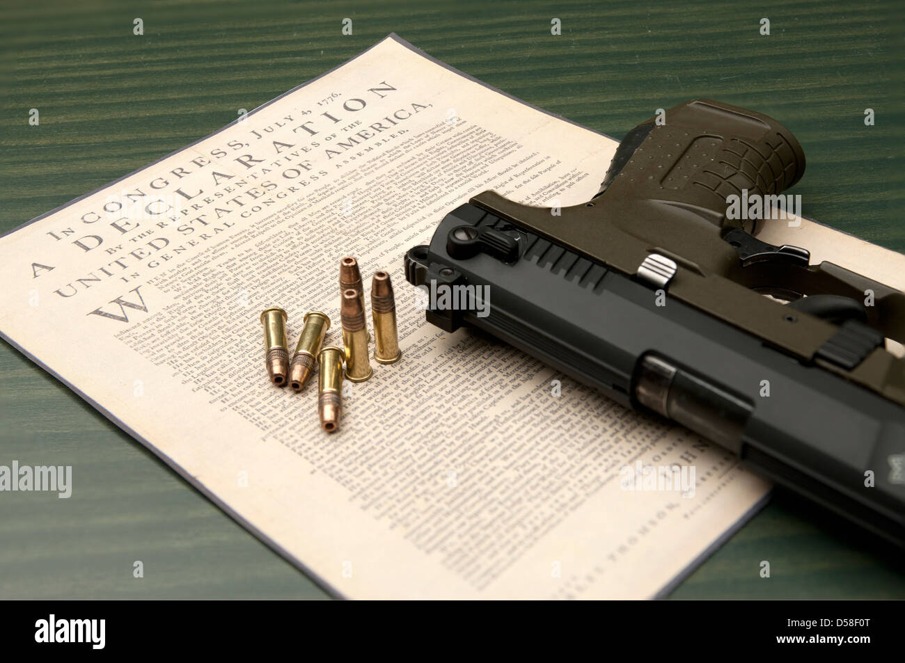 Hand gun with bullets resting on the Declaration of Independence Stock ...