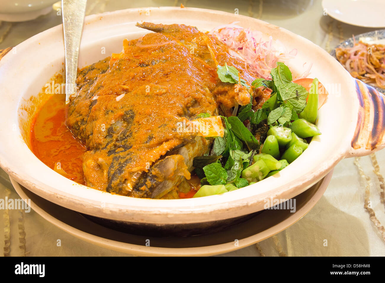 Nyonya Fish Head Curry with Mint Leaves Okra Tomato and Onions Stock ...
