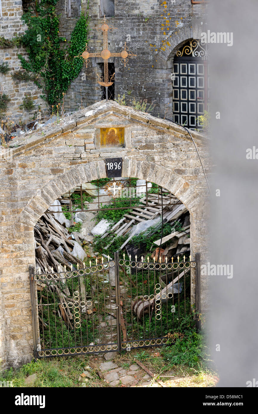 Entrance to a decayed church with the icon of The Mother of God above ...