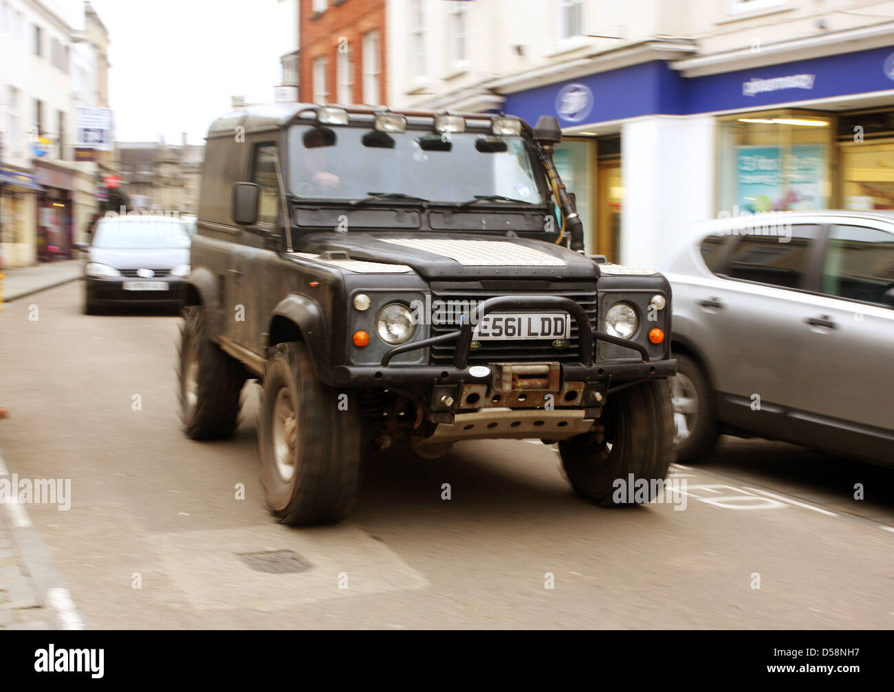 Land rover at speed in the city. Old Land rover 4x4 on giant big wheels ...