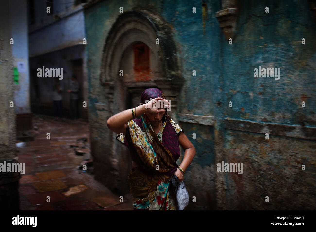 Sep 13, 2012 - Varanasi, India - a women walks through the narrow alley ...