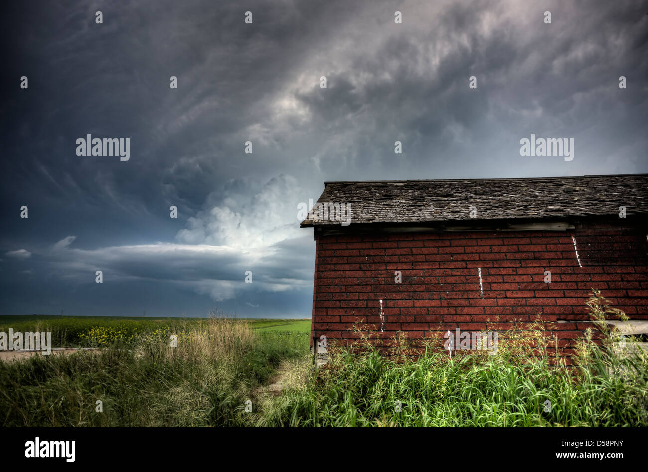 Storm Clouds Saskatchewan Red buildings granary storage Stock Photo - Alamy