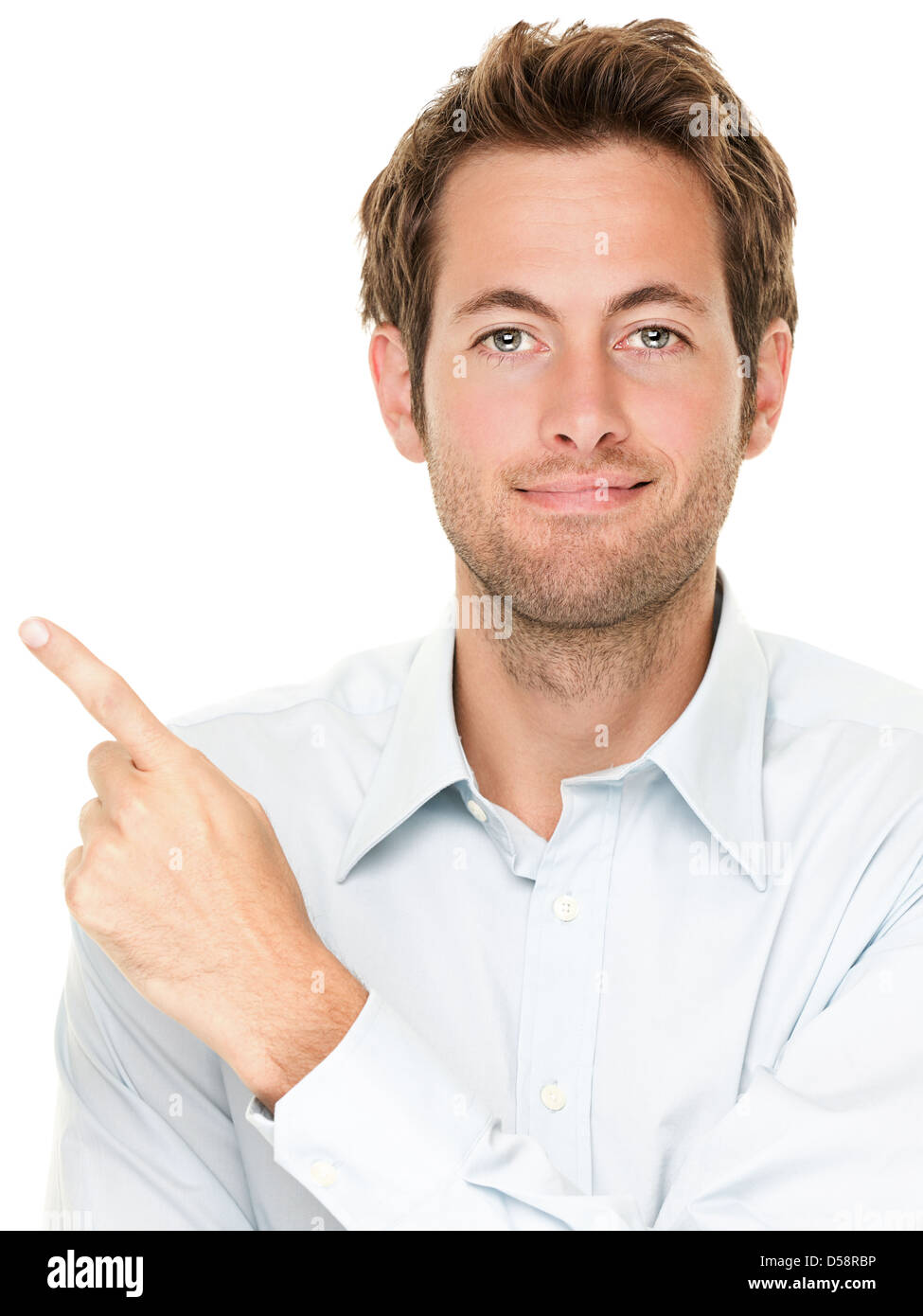 Portrait of handsome Caucasian young man pointing towards copyspace ...