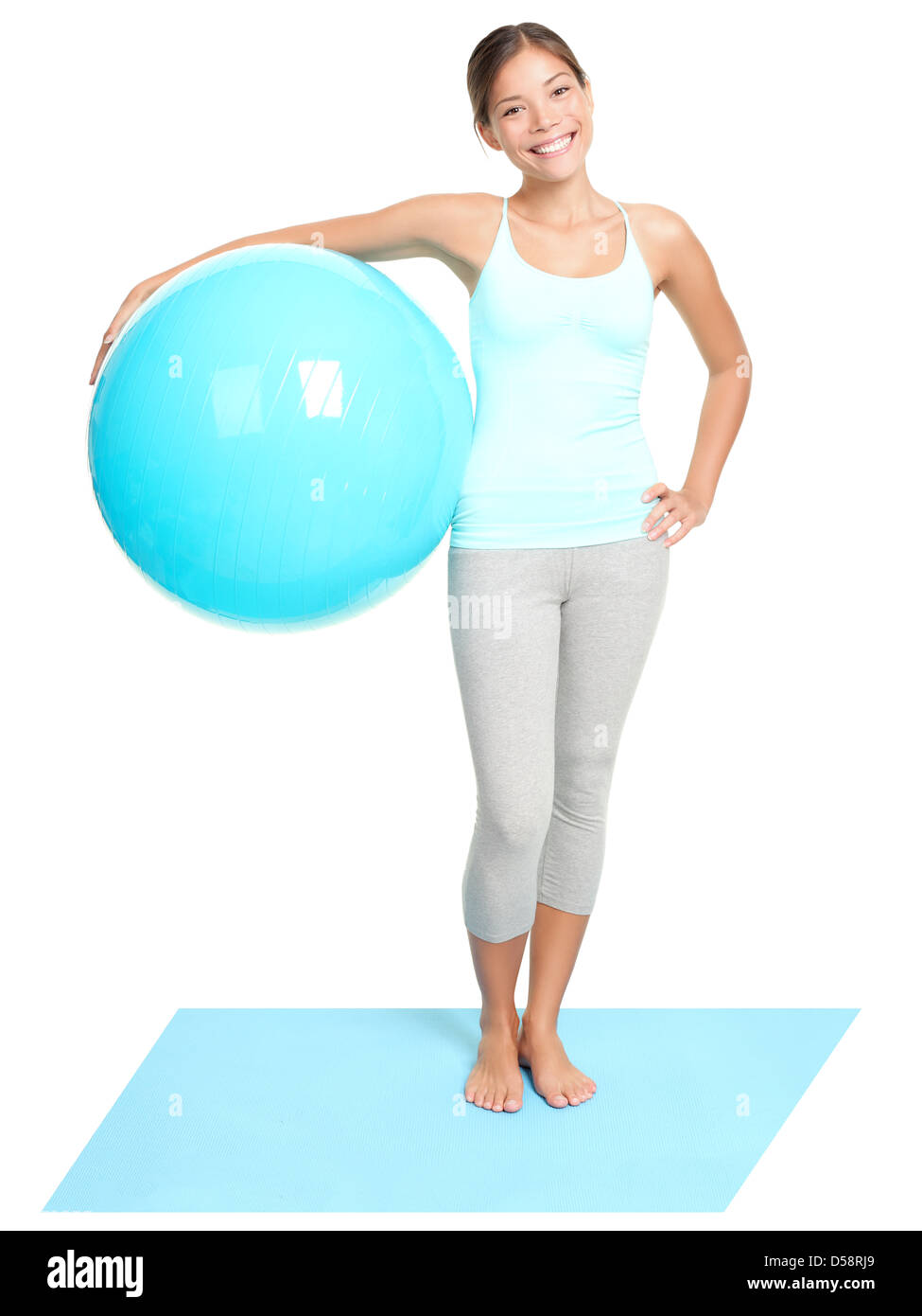 Portrait of young sporty fit mixed race Asian / Caucasian woman holding ...
