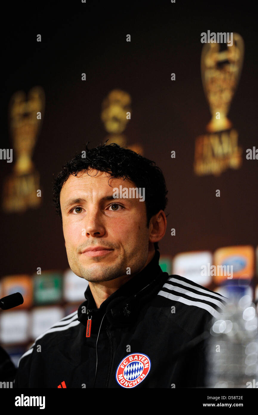 In the handout image provided by UEFA, Bayern captain Mark van Bommel ...