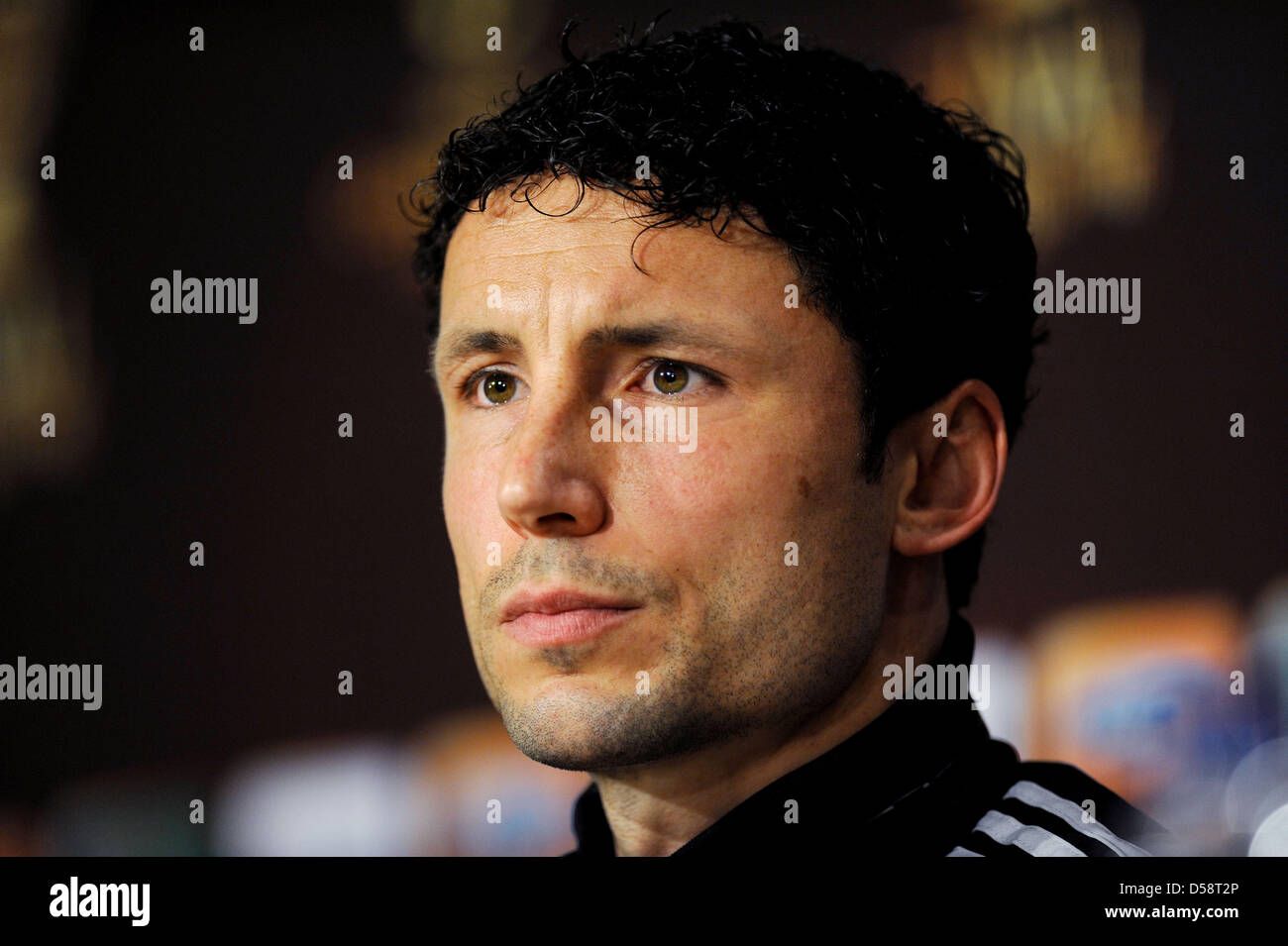 In the handout image provided by UEFA, Bayern captain Mark van Bommel ...