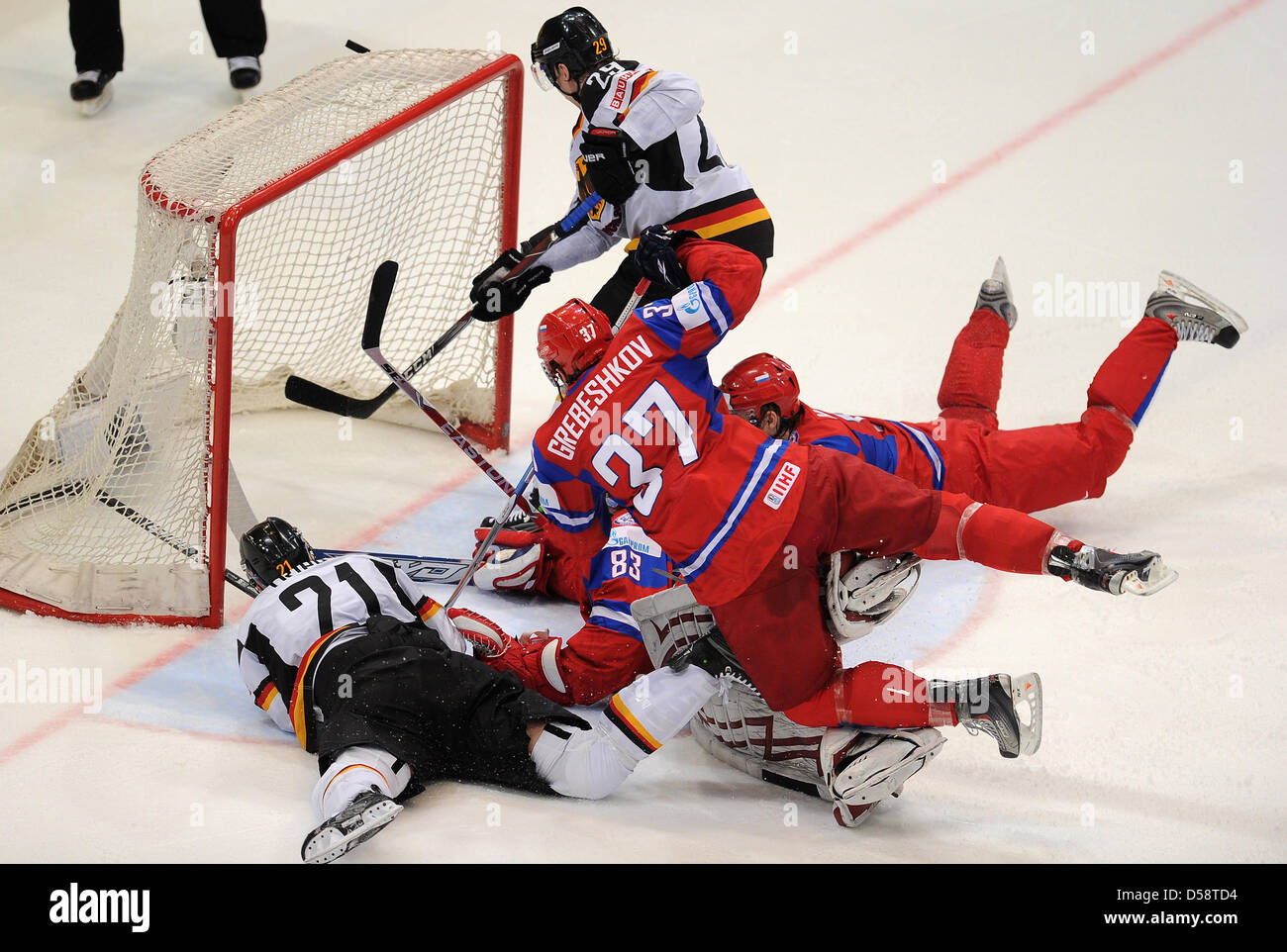 Germany's John Tripp (L) and Marcel Mueller (R) fight for the puck with ...