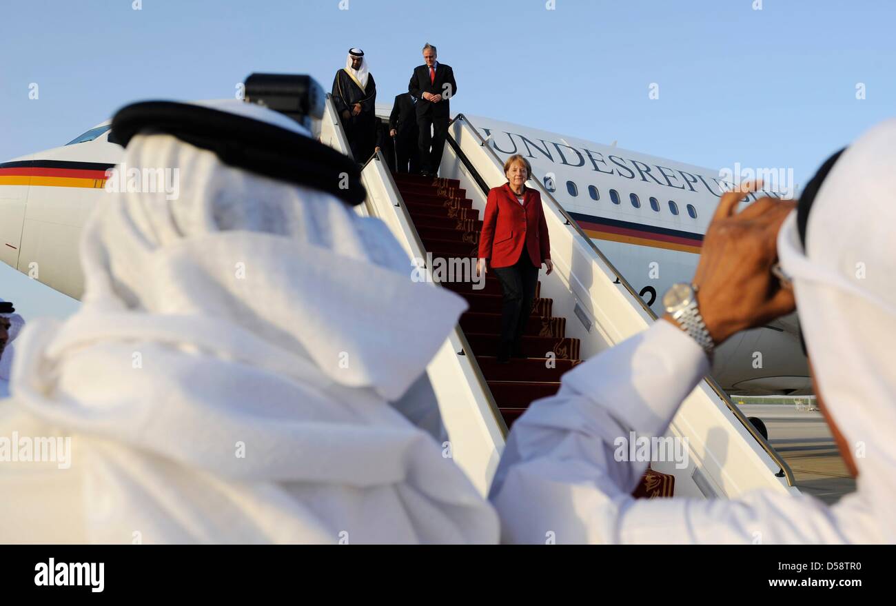 German Chancellor Angela Merkel leaves her plane at the airport in Abu ...