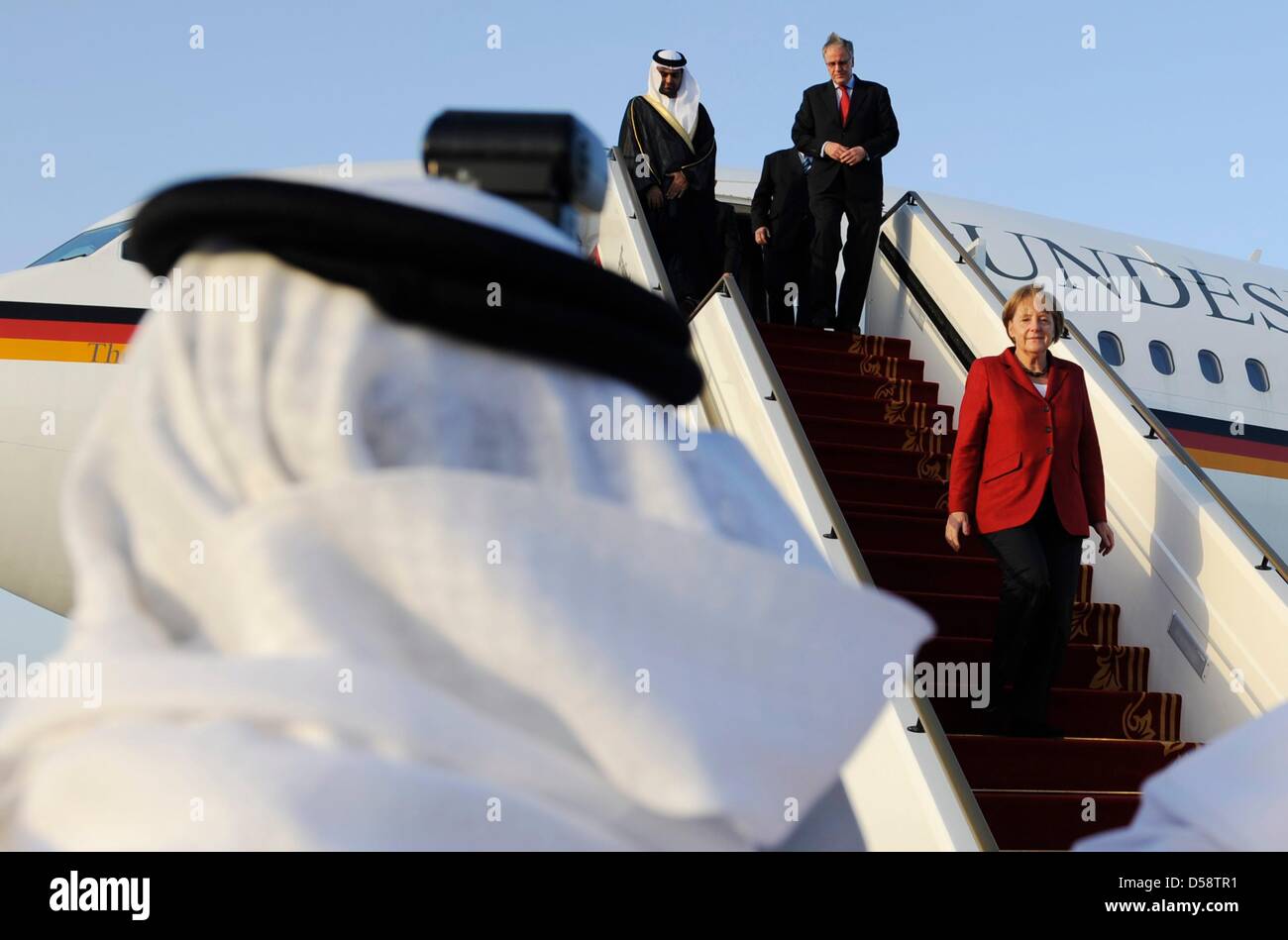 German Chancellor Angela Merkel leaves her plane at the airport in Abu ...