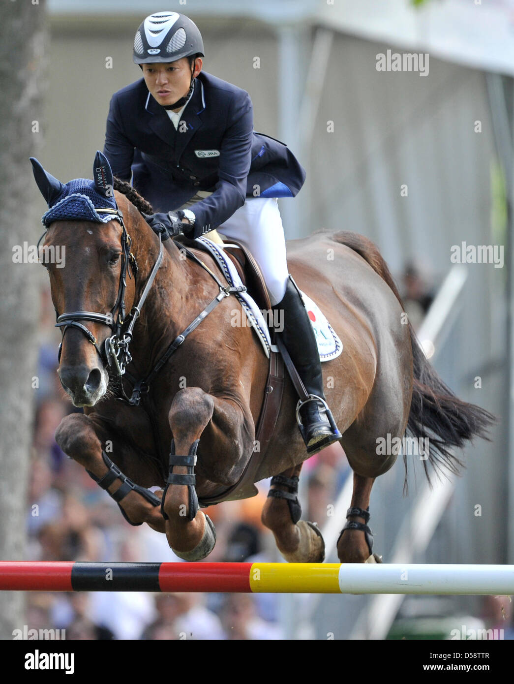 Japanese Fukushima Daisuke and his horse 'Weldon D. 05' clear an obstacle during the Great Prize ...
