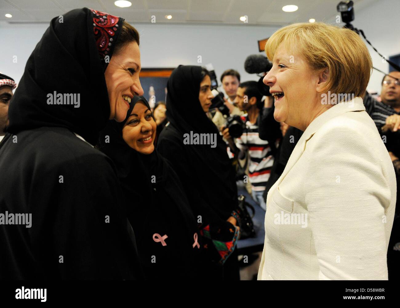 German Chancellor Angela Merkel (R) talks to female Saudi Arabian ...