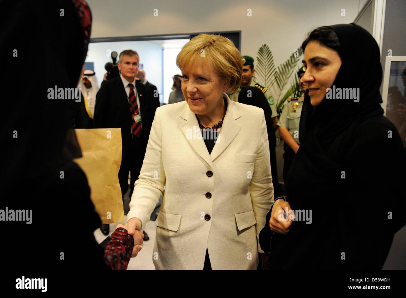German Chancellor Angela Merkel (C) talks to female Saudi Arabian ...