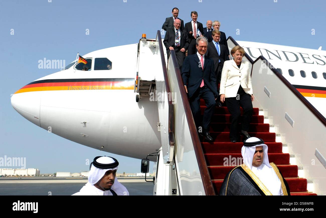 German Chancellor Angela Merkel (R) leaves the government airplane at ...