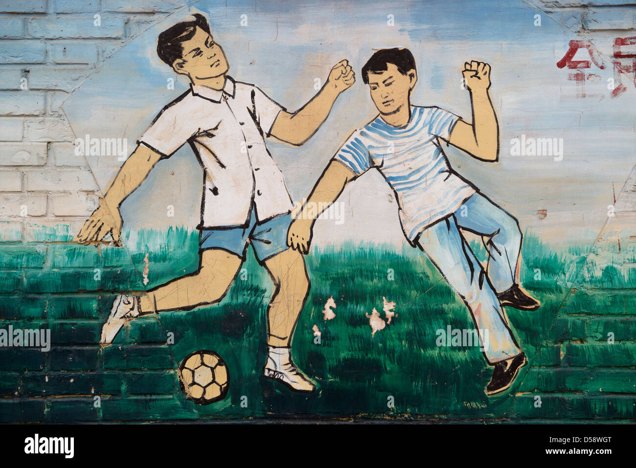A poster featuring Chinese play football in a village in Langfang ...
