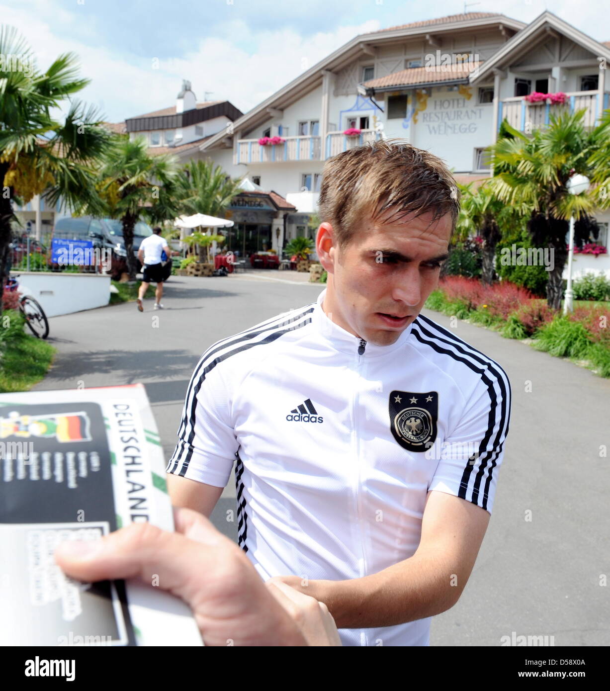 German international Philipp Lahm signs autographs in front of the team ...