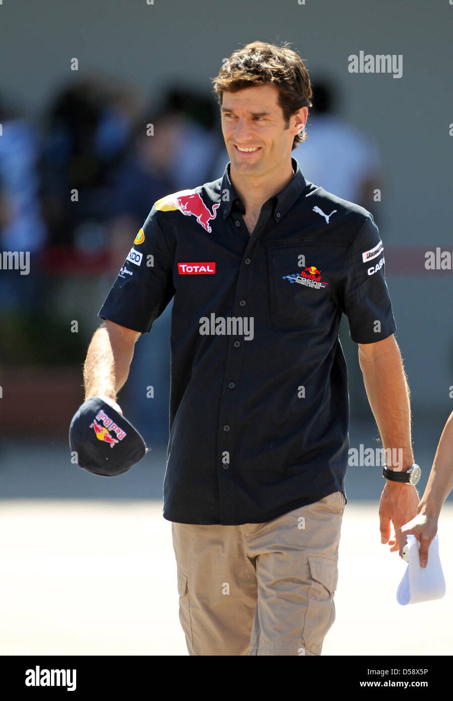 Australian driver Mark Webber of Red Bull Racing walks through the ...