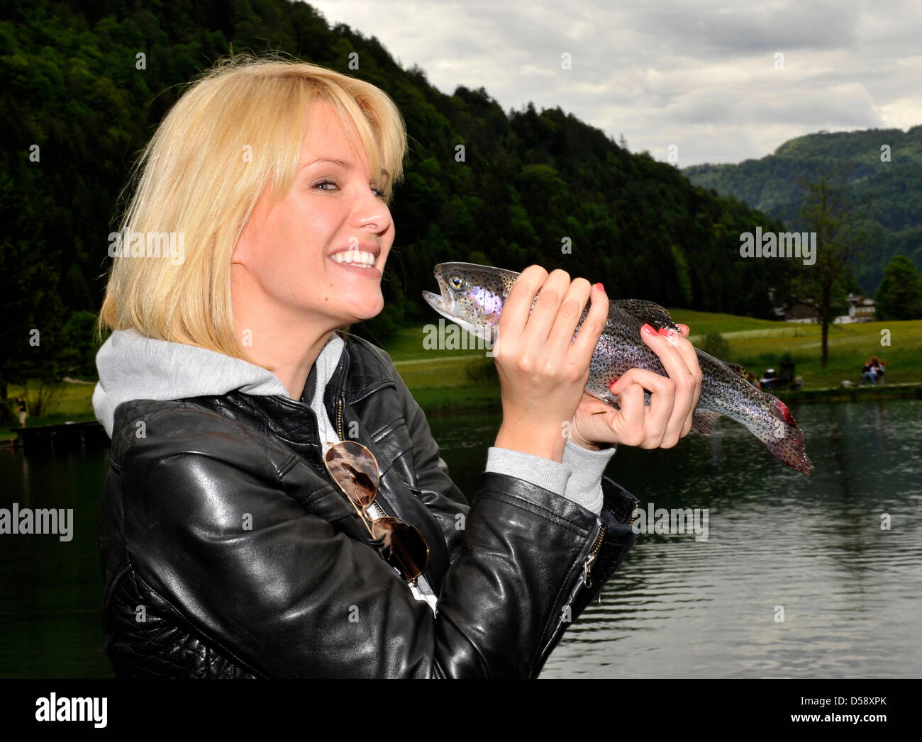 Presenter Monica Ivancan poses with a rainbow trout, that she caught ...