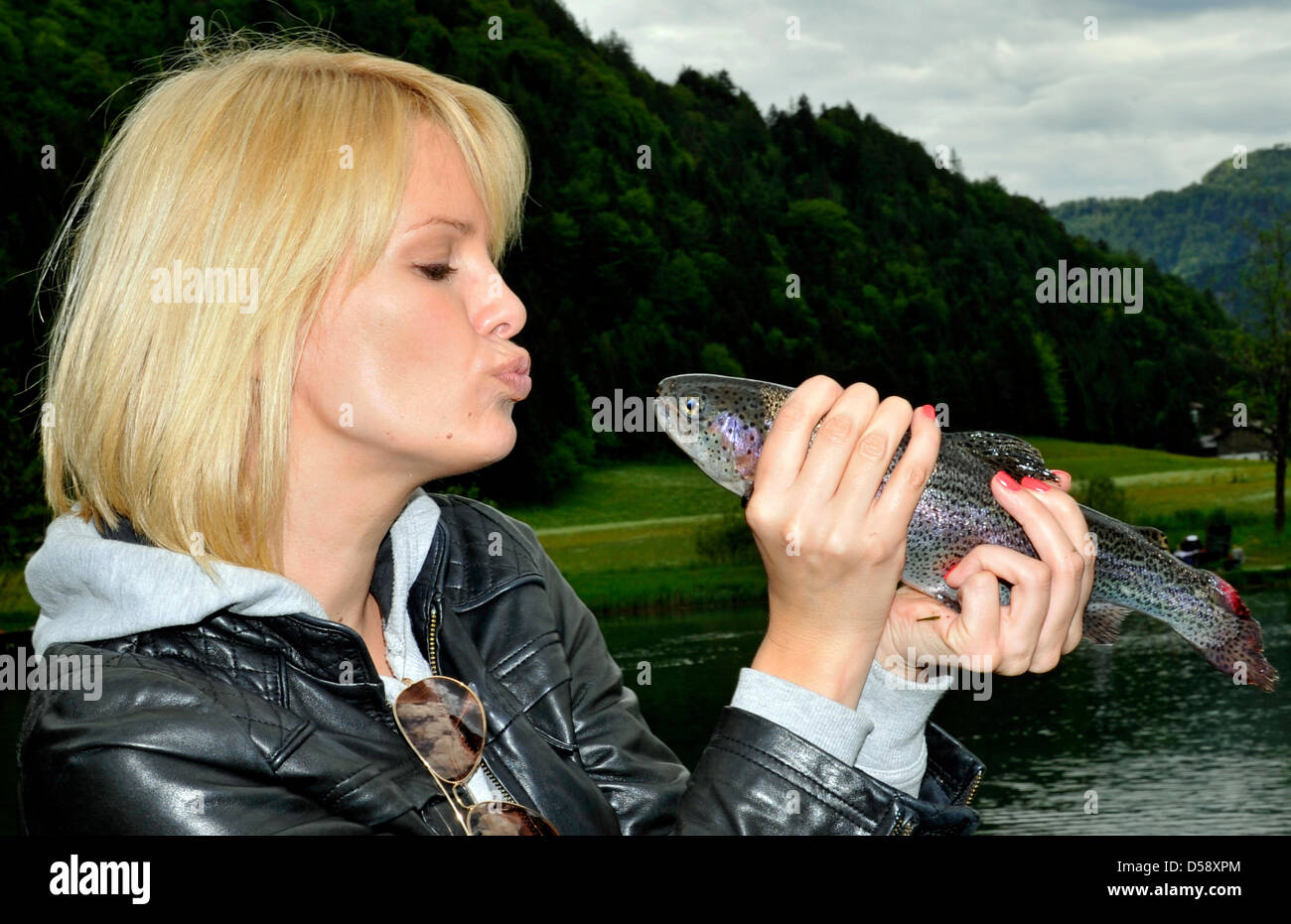 Presenter Monica Ivancan poses with a rainbow trout, that she caught ...