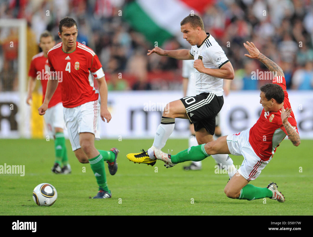 Germany's Lukas Podolski (C) and Roland Juhasz (L) and Laszlo Bodnar (R ...