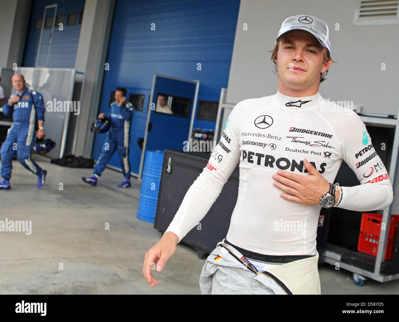 German driver Nico Rosberg of Mercedes GP walks through the paddock ...