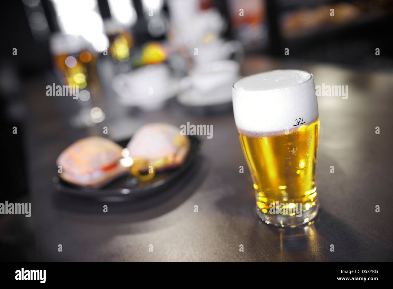 closeup of a beer glass in a bar Stock Photo - Alamy