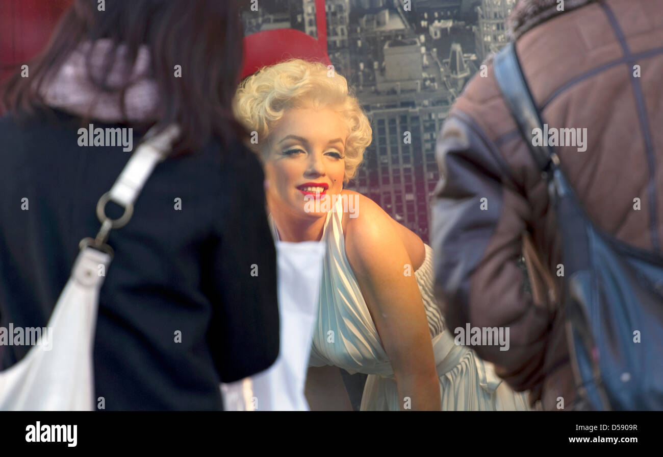 People take a look at a Marilyn Monroe figure in the window of Madame ...