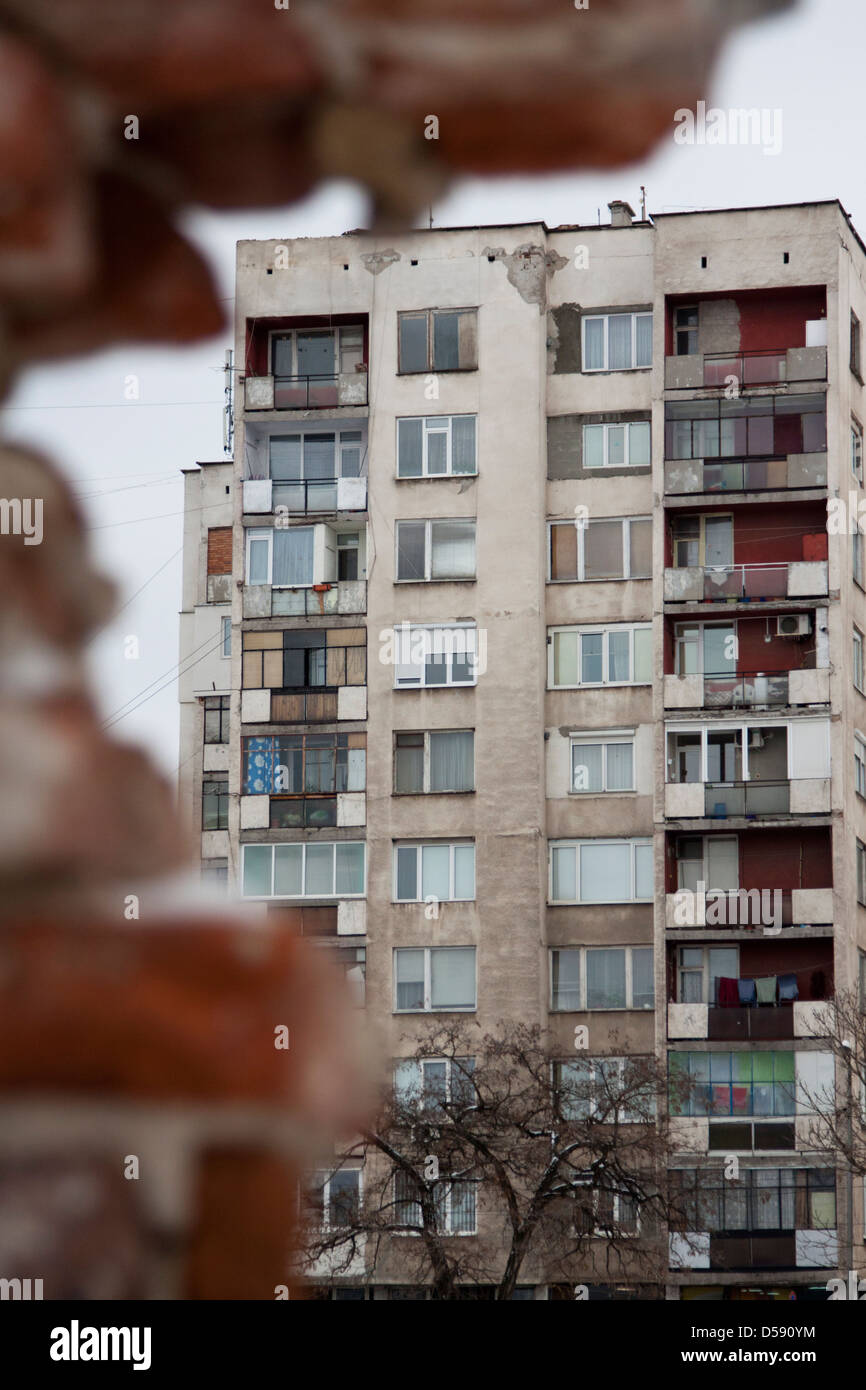 Pernik - a town in Bulgaria: apartment block seen through a ruined ...