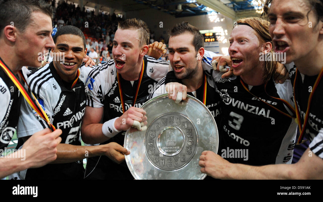 Kiel's players celebrate with the trophy for winning the German ...