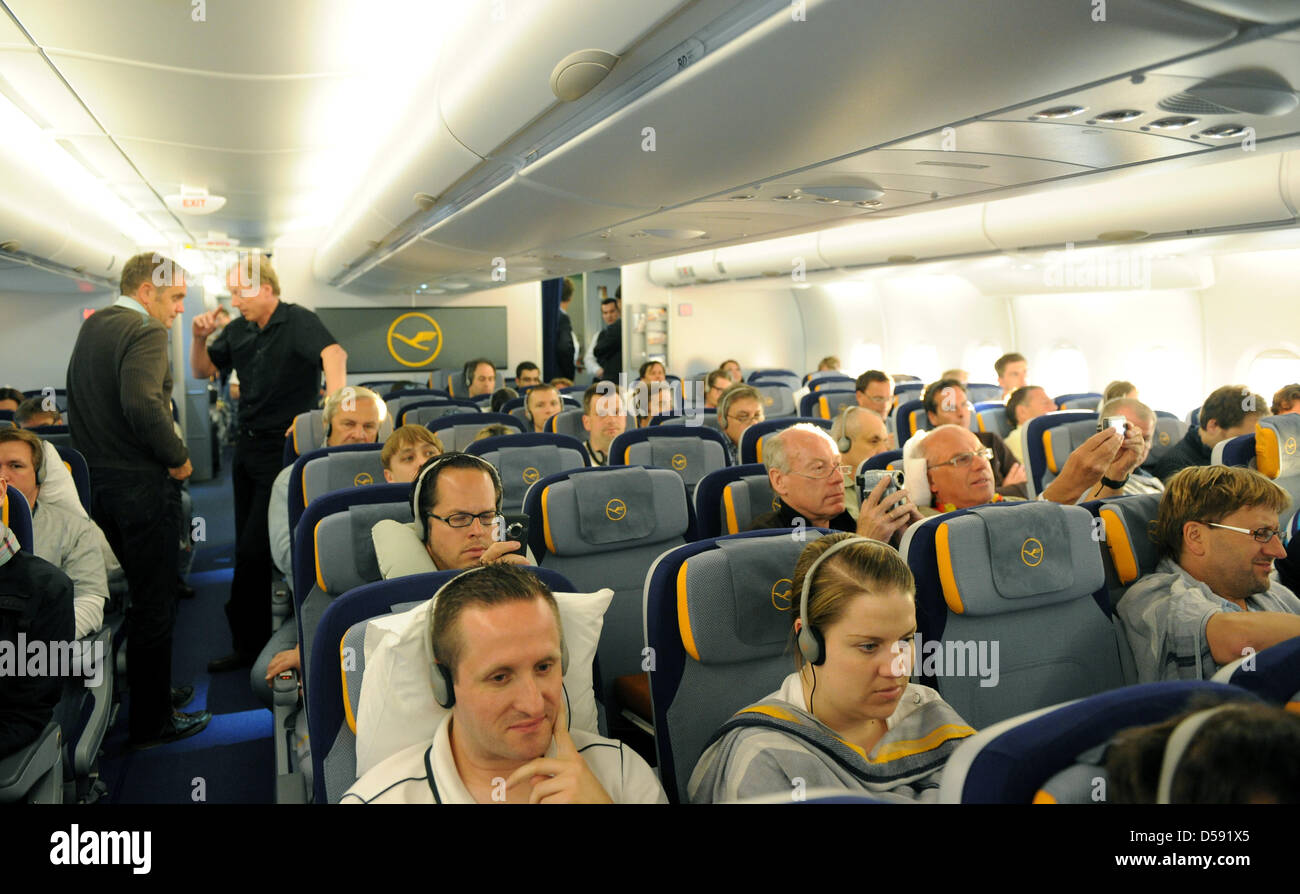 Fans of the German national squad and journalists sit in the Airbus ...