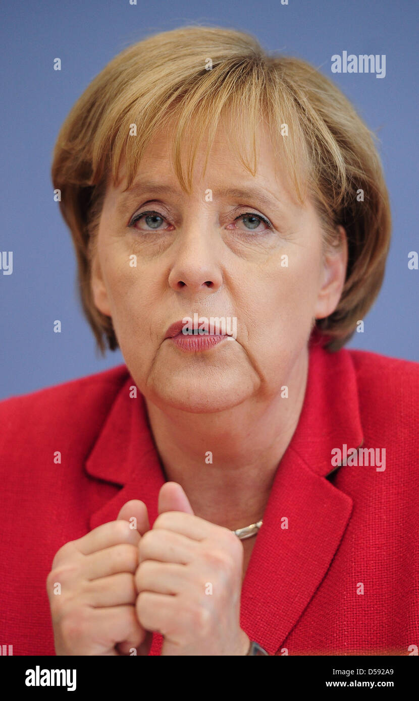 German Chancellor Angela Merkel gestures as she infroms the press about ...