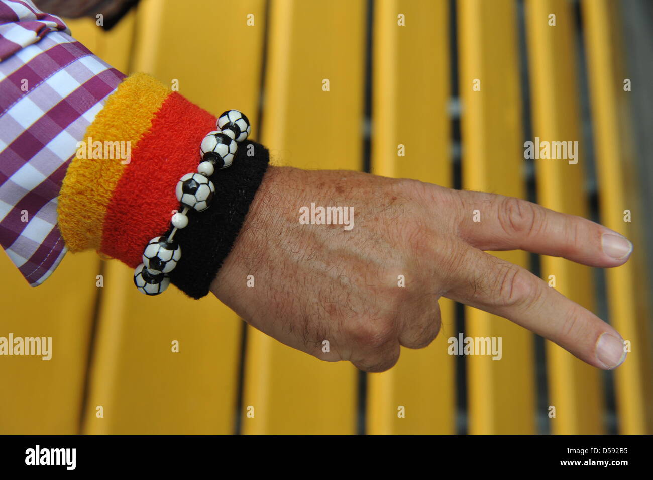 A man's hand signals a victory sign in Munich, Germany, 07 June 2010 ...
