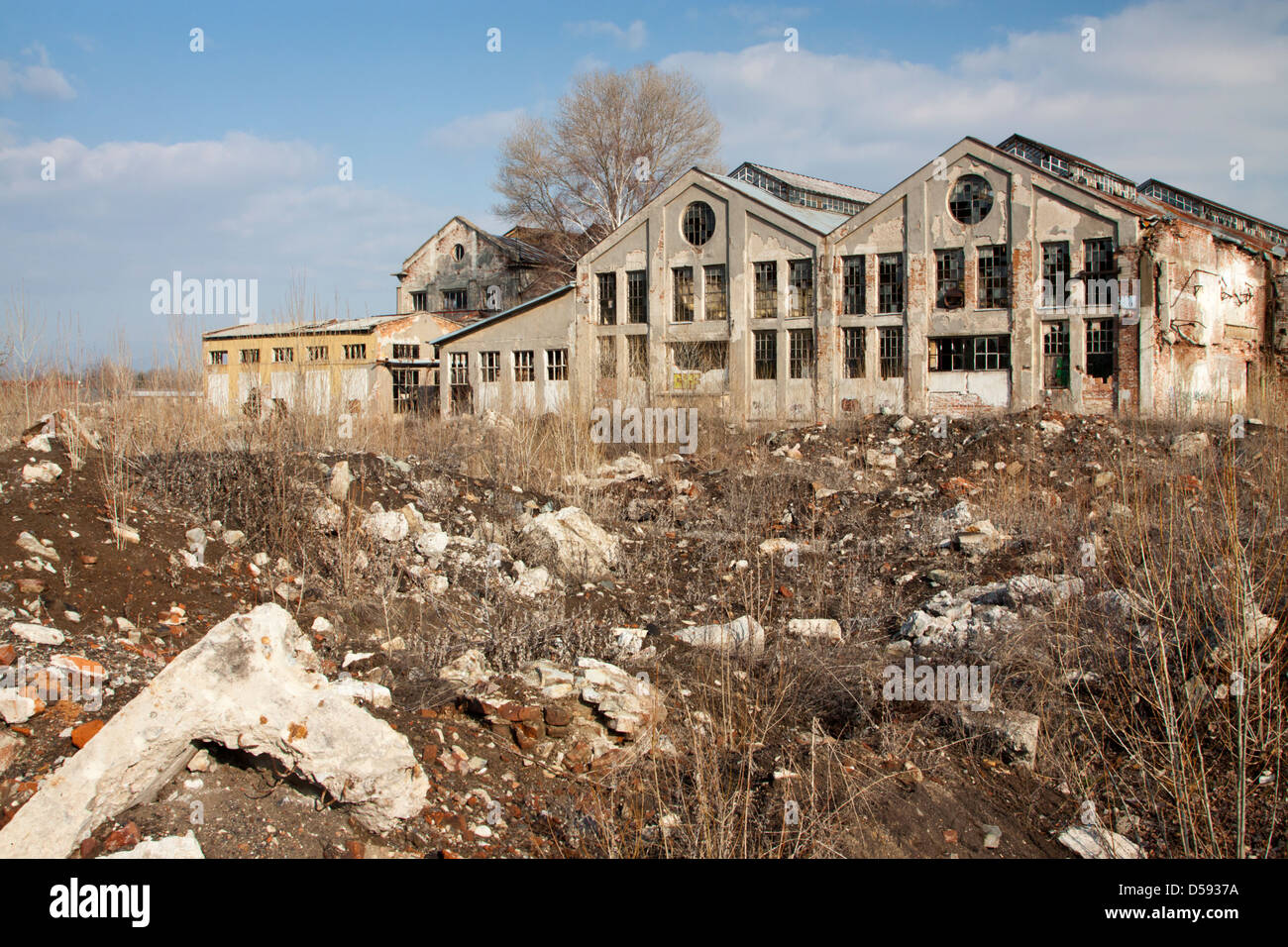 Abandoned railway depot - ruined factory halls in a field of rubble ...