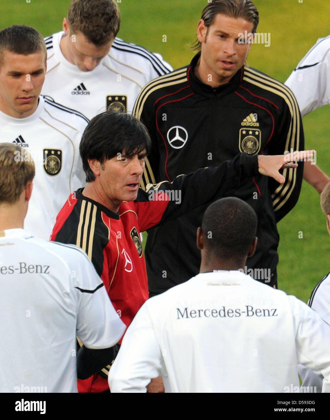 Germany head coach Joachim Loew (C) talks to his players during a ...