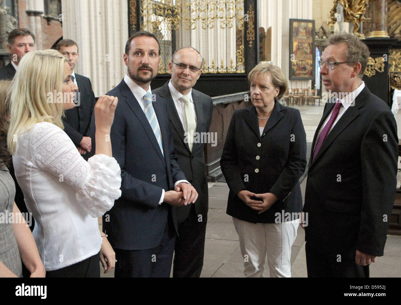 Pastor Hanns-Peter Neumann (R) explains the sights to Norway's Crown ...