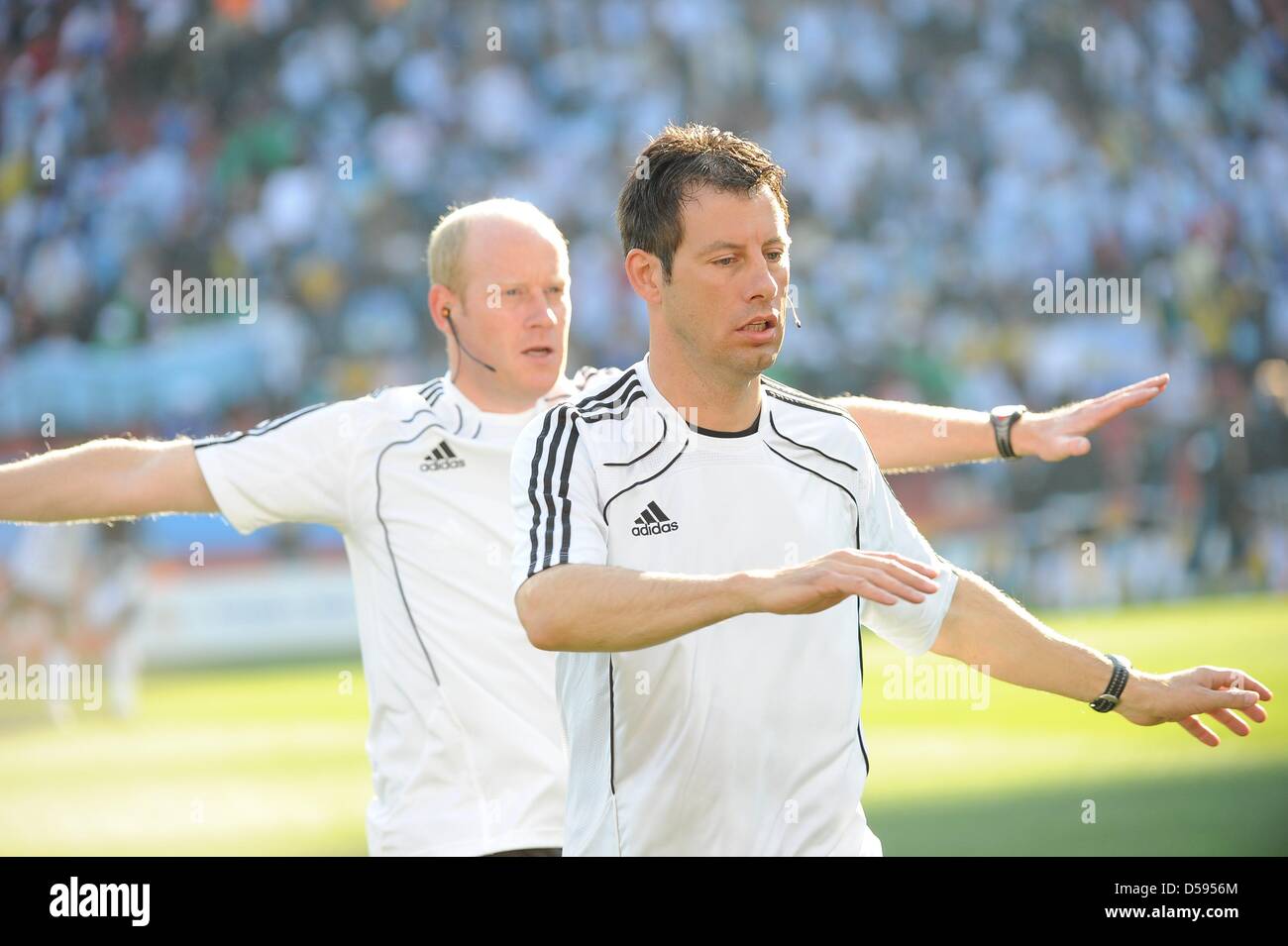 German referee Wolfgang Stark (R) and assistant referee Jan Hendrik ...