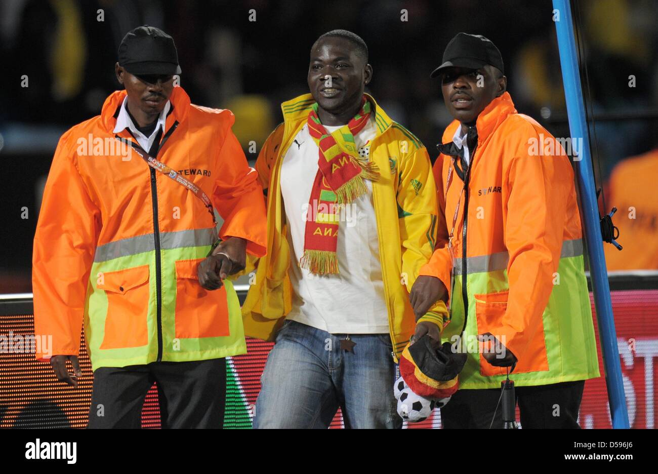 Security guards lead a fan away during the FIFA World Cup 2010 group D ...