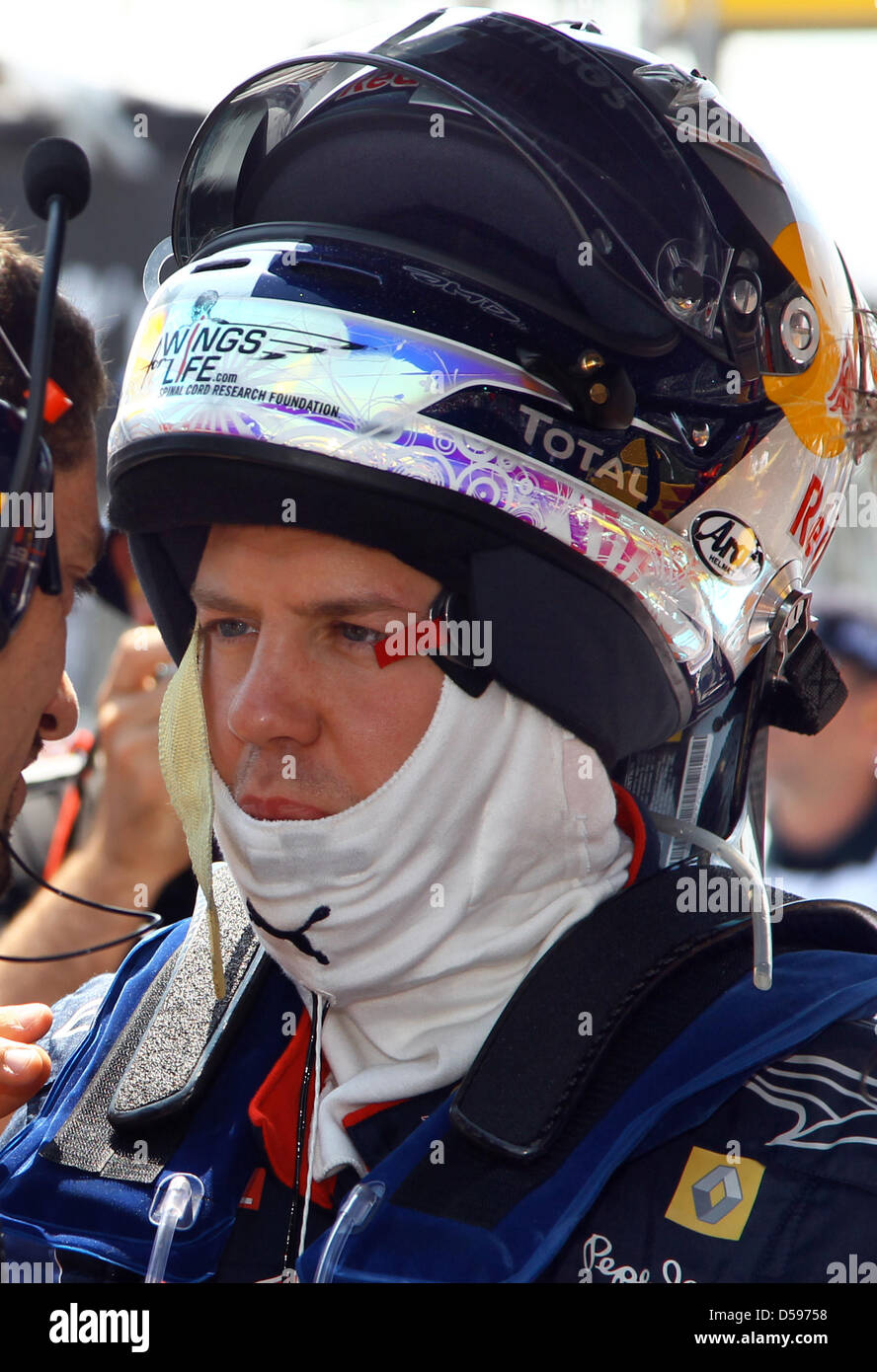 German driver Sebastian Vettel of Red Bull Racing waits in the grid for ...