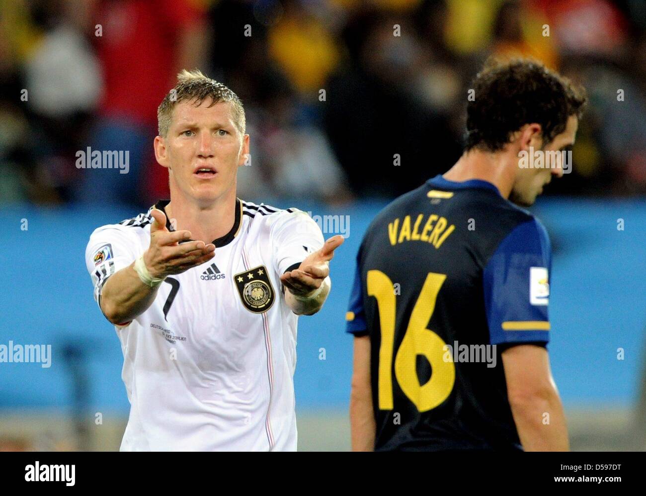 Germany's Bastian Schweinsteiger gestures next to Australia's Carl ...