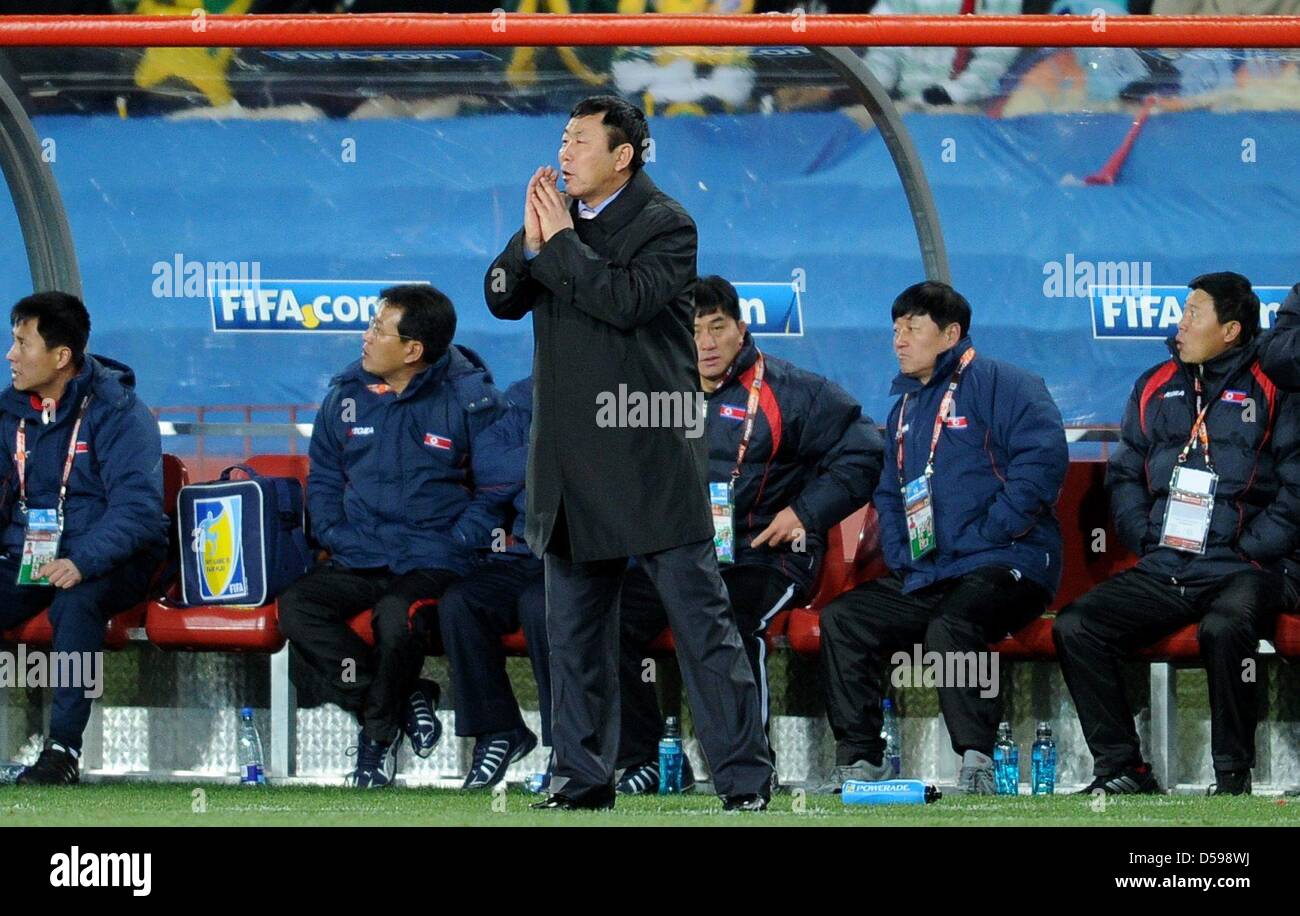 Korea's coach Kim Jong Hun reacts on the sideline during the 2010 FIFA ...