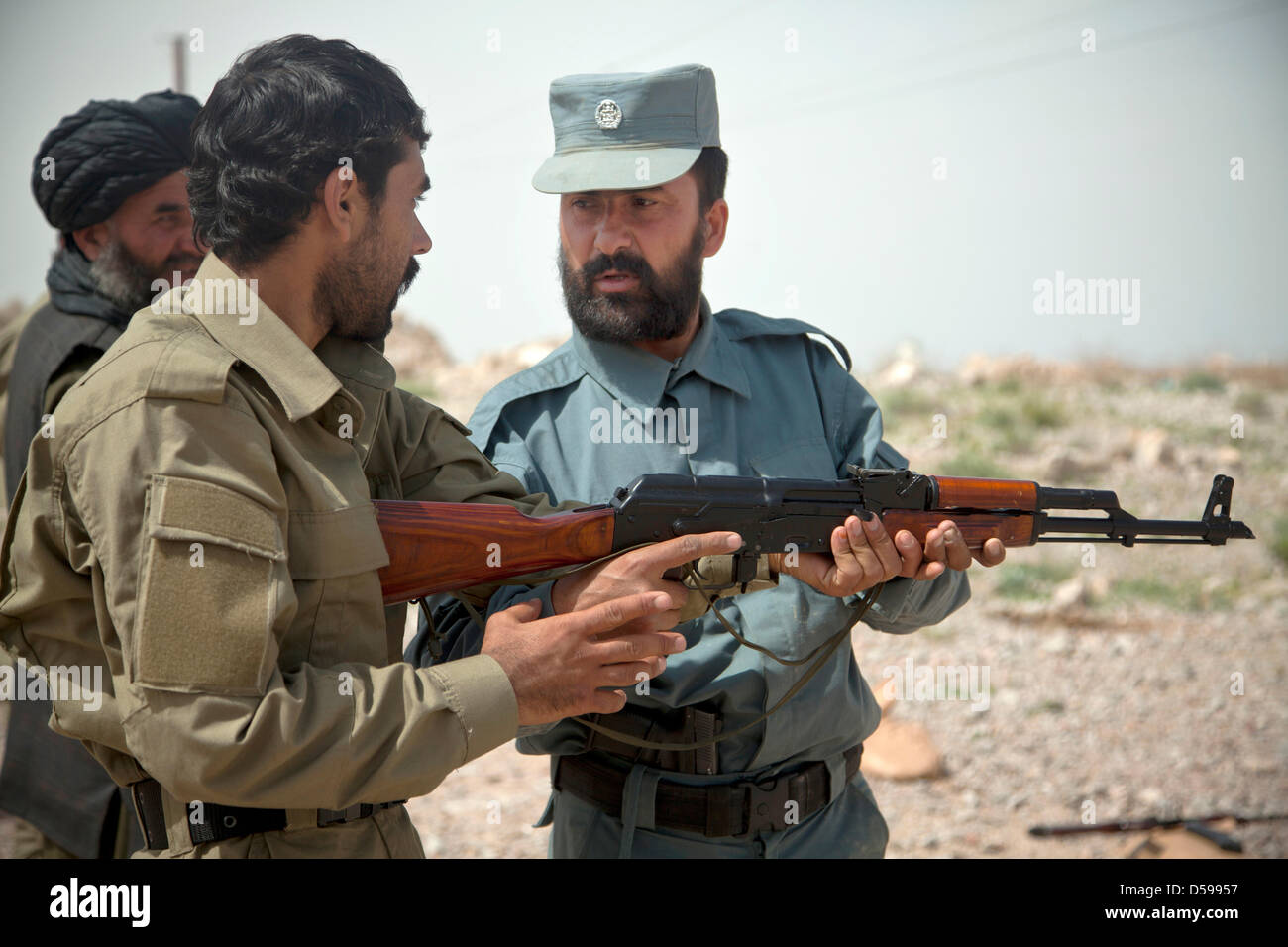 An Afghan National Police instructor shows Afghan Local Police how to ...