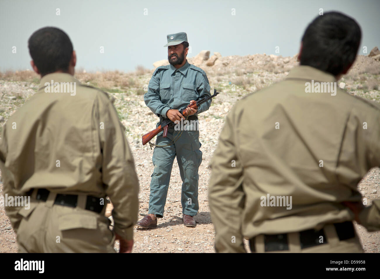 An Afghan National Police instructor shows Afghan Local Police how to ...