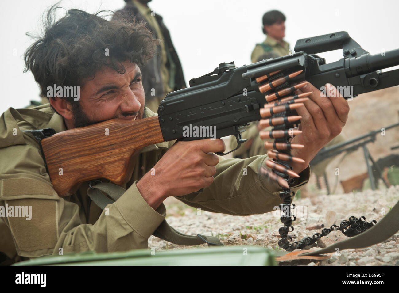 Afghan Local Policemen fire a machine gun during weapons training ...