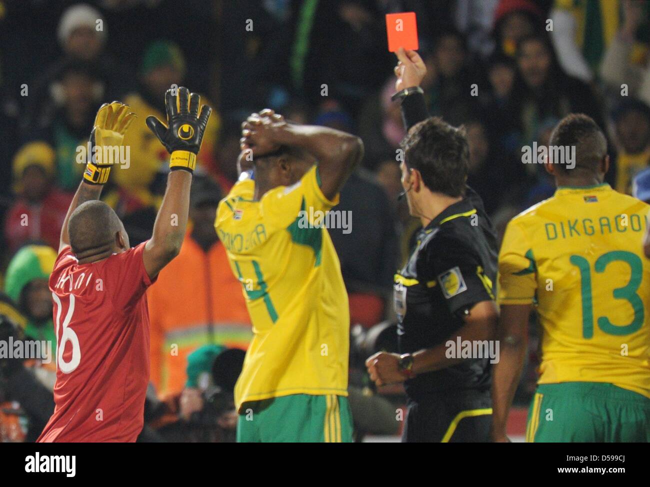 Referee Massimo Busacca (2-R) shows Itumeleng Khune (L) of South Africa ...