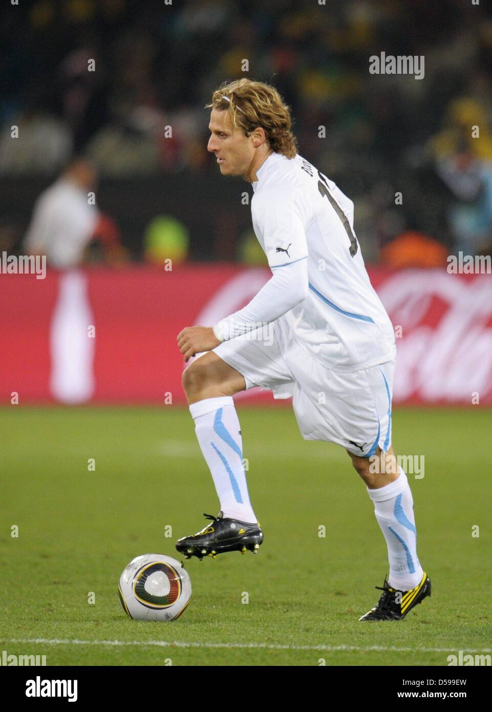 Diego Forlan of Uruguay (L) controls the ball during the FIFA World Cup ...