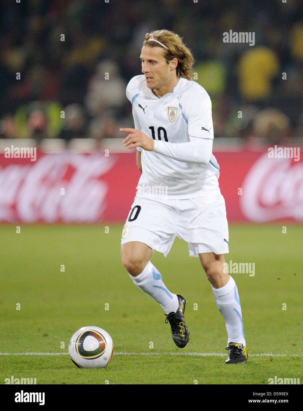 Diego Forlan of Uruguay (L) controls the ball during the FIFA World Cup ...