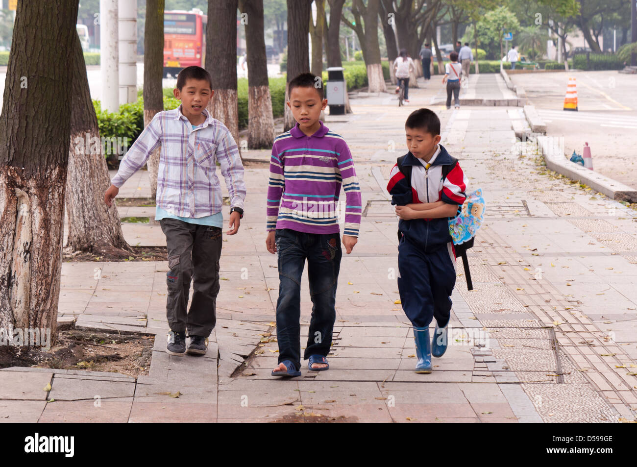 Three little boys walking in the street Stock Photo - Alamy